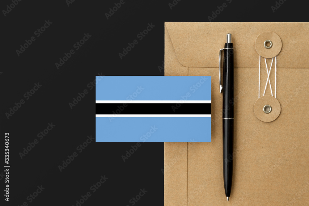 Botswana flag on craft envelope letter and black pen background ...