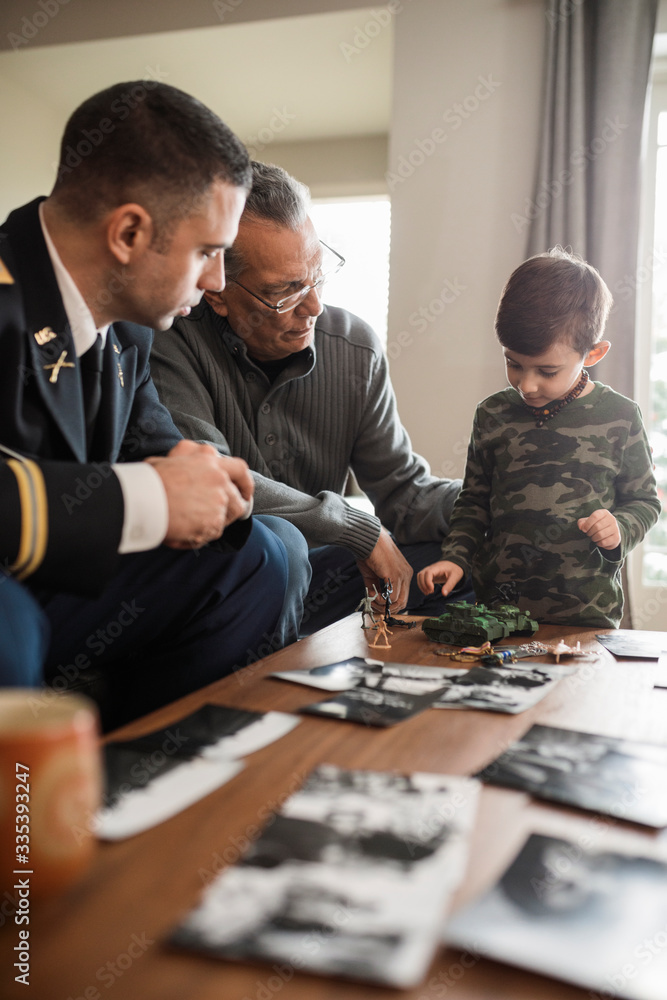 Multi-generation family looking at military memorabilia Stock Photo ...