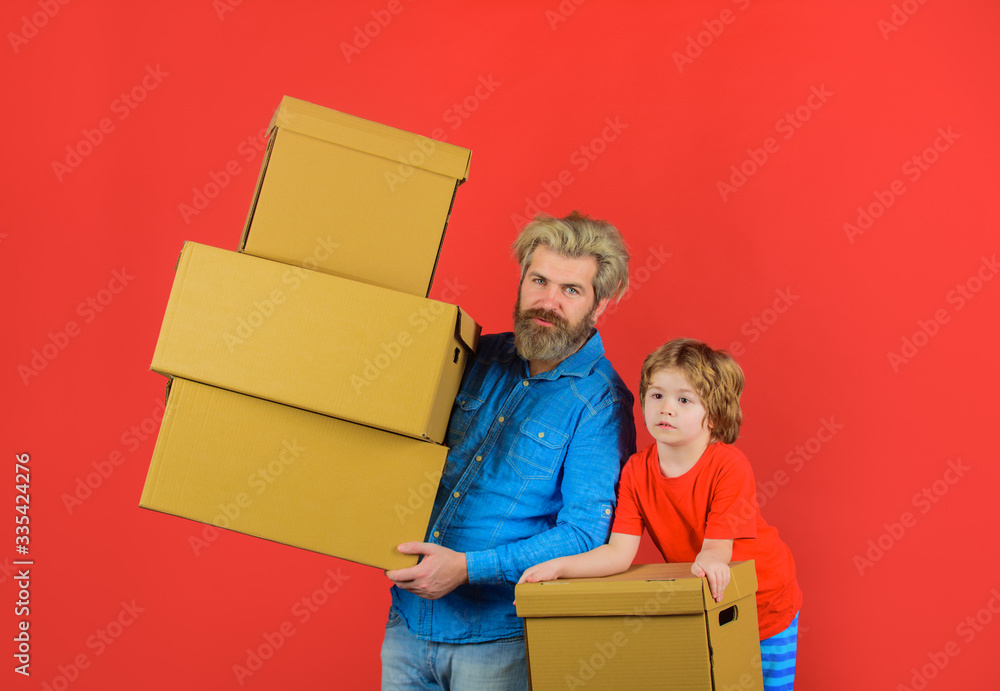 Moving concept. Happy little son and father with cardboard box ...