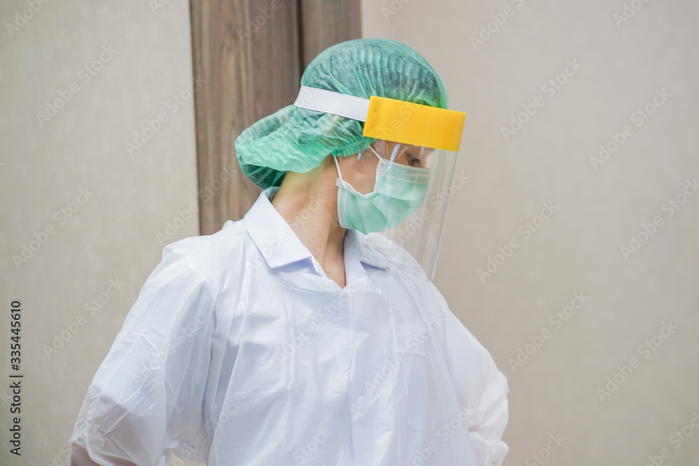 Front-line healthcare workers prepare wearing Personal Protective ...