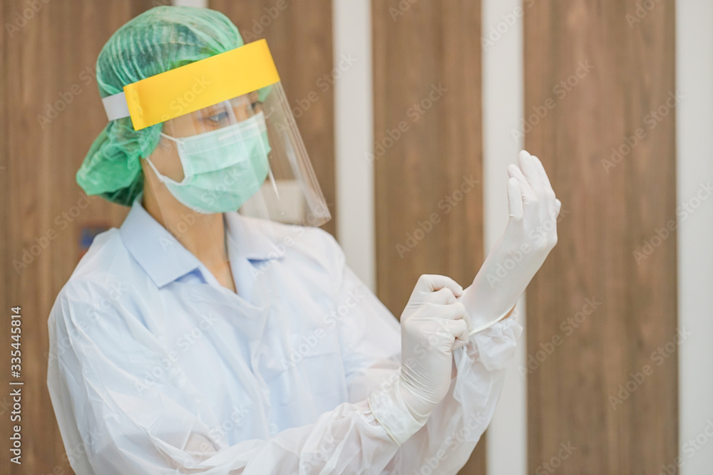 Front-line healthcare workers prepare wearing Personal Protective ...