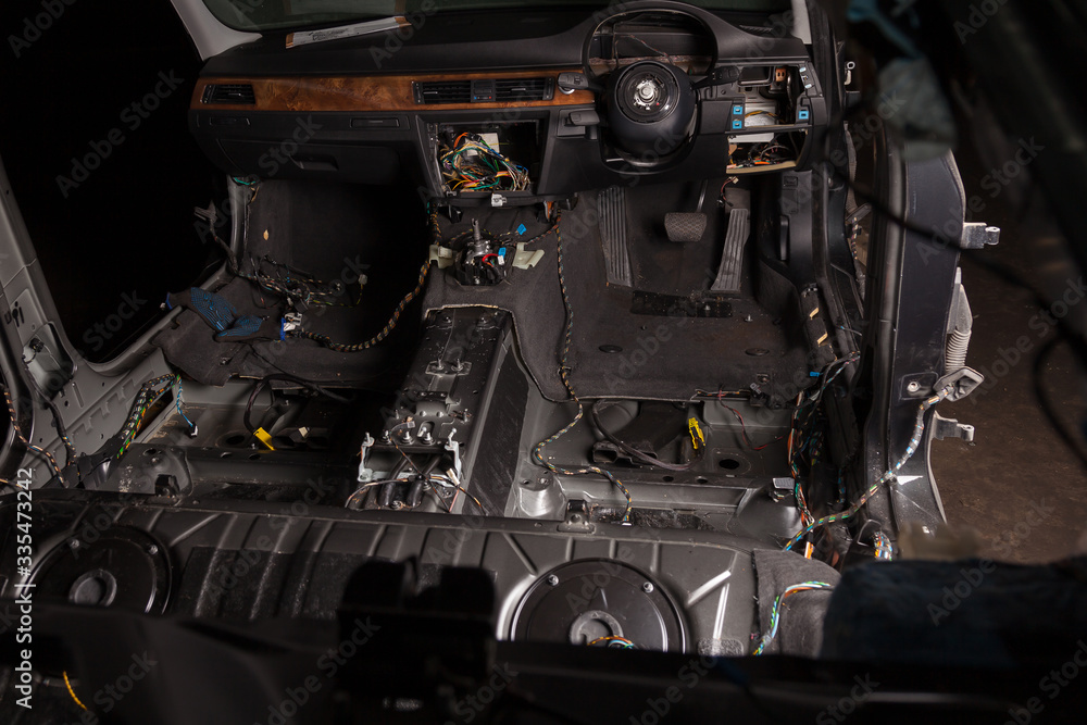 Car interior in the back of a sedan with a disassembled dashboard and ...