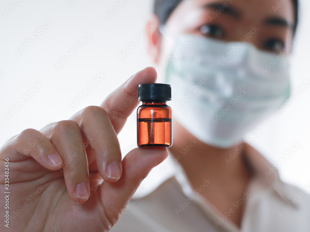 Asian female doctor holding medicine bottle for injection. Medical ...