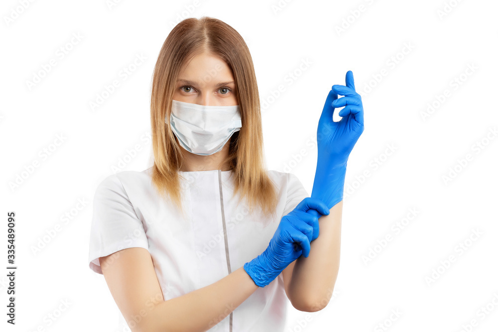 Female nurse wearing protection face mask is putting on medical latex ...