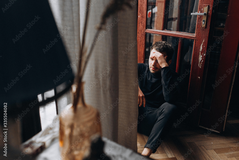 Sad man. Sad man on the floor. The guy sits on the floor and thinks ...