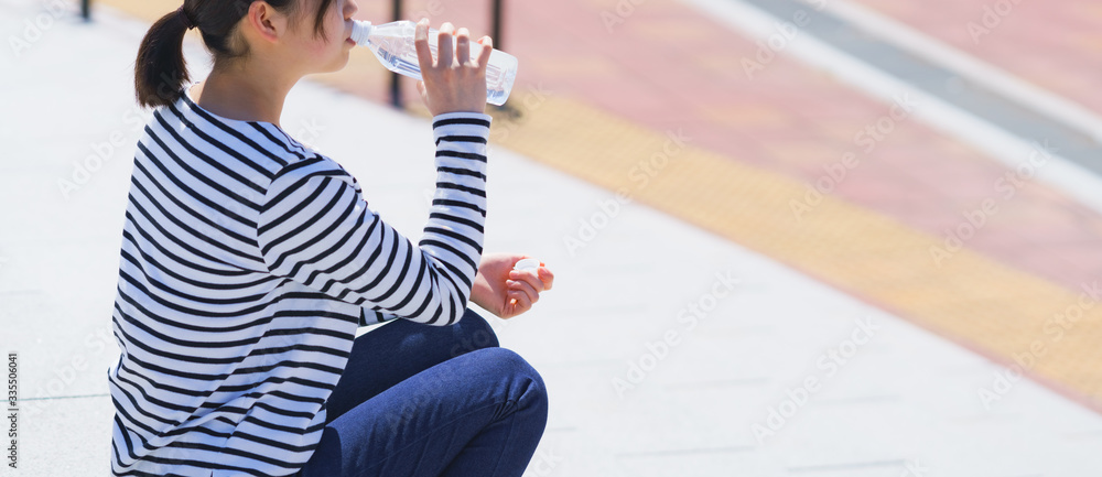 College student drink mineral water in pet bottle on campus in Japan ...