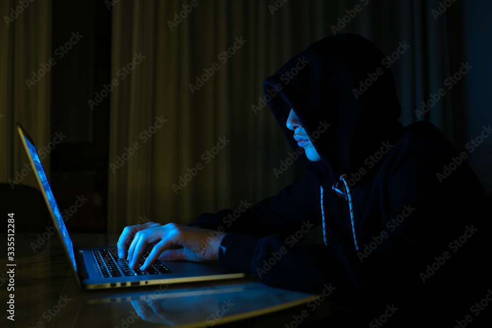Foto de Hacker is hacking into the computer network. Young boy in a ...