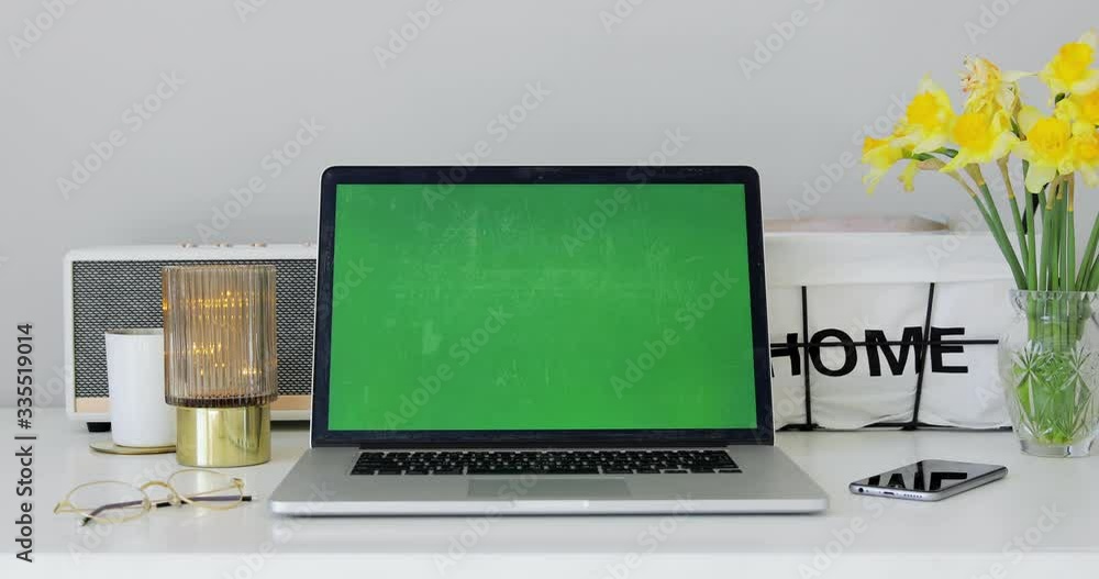 4K Chroma key green screen of laptop MacBook Pro set on working space ...