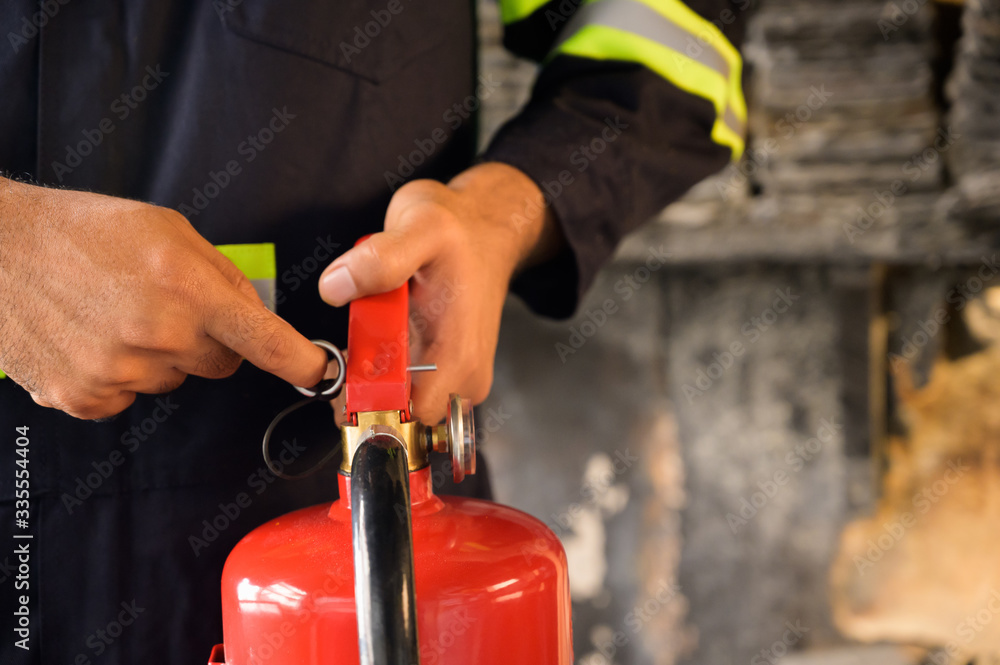 Close up hand Fireman using fire extinguisher fighting. Hand pulling ...
