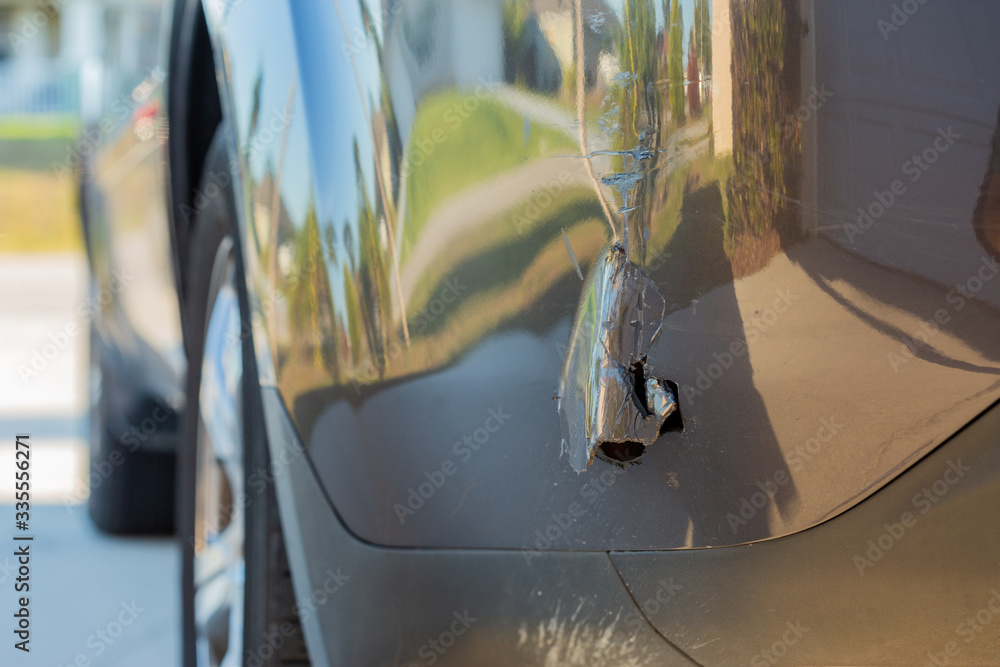 Car with damaged rear bumper. Rims showing in the blurred background ...