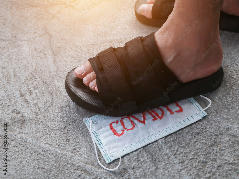 People treading on dirty used surgical face mask to protect Covid-19 on ...