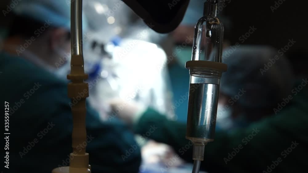 IV (infusion) bags and bottles hanging on poles during a real surgery ...