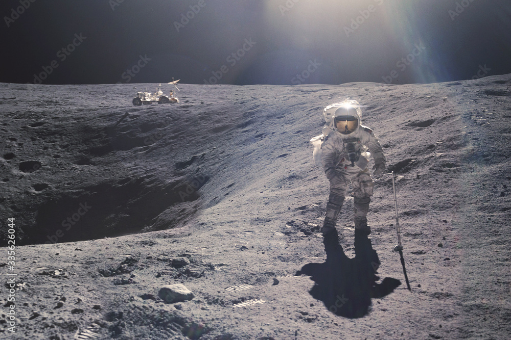 Astronaut on rock surface with space background. Elements of this image ...