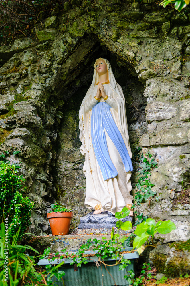 Virgin Mary statue at a grotto at a holy shrine Stock Photo | Adobe Stock