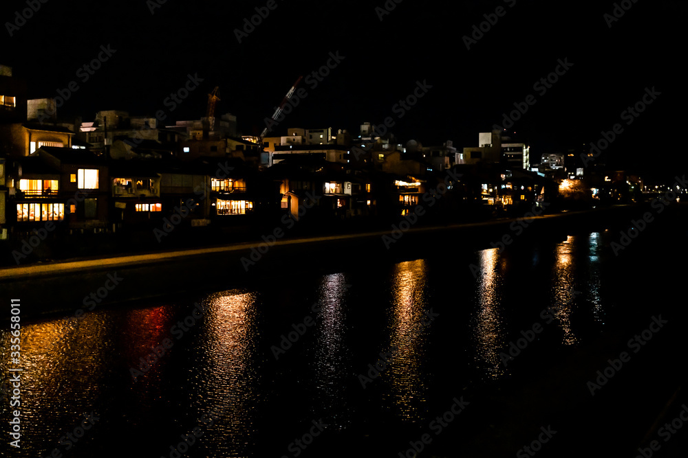 Kyoto, Japan illuminated waterfront houses reflection along Kamo river ...