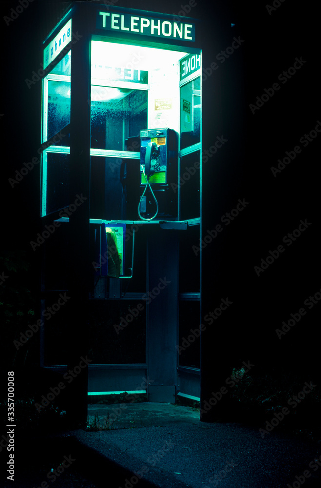 Telephone booth at night with interior lights Stock Photo | Adobe Stock