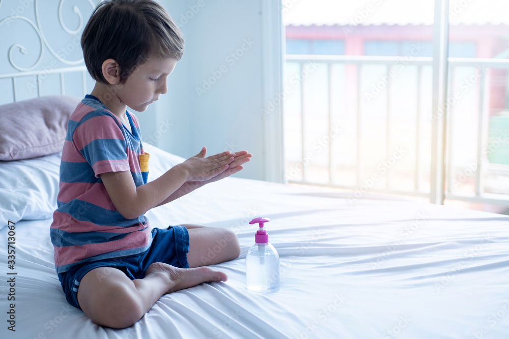 Cute caucasian boy rubbing her hand. he washed his hands with sanitizer ...