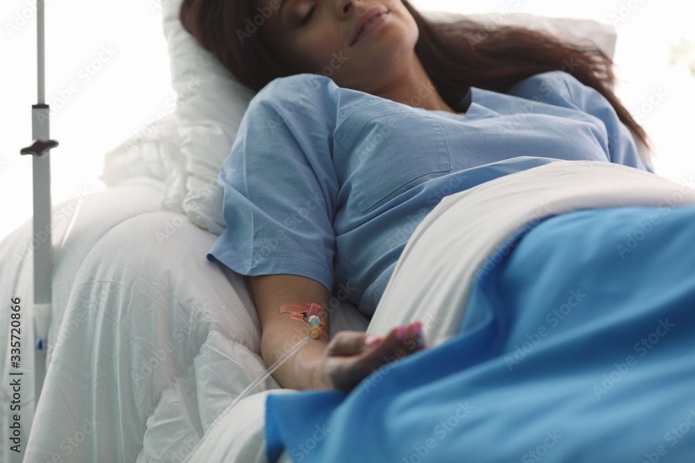Beautiful girl lies hospital with droplet her hand. Diagnosis treatment ...