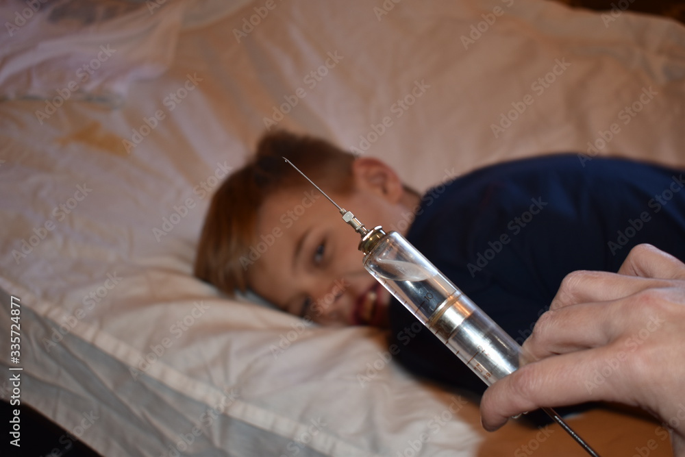 The boy put a shot. Big scary syringe. Frightening doctor . Mandatory ...