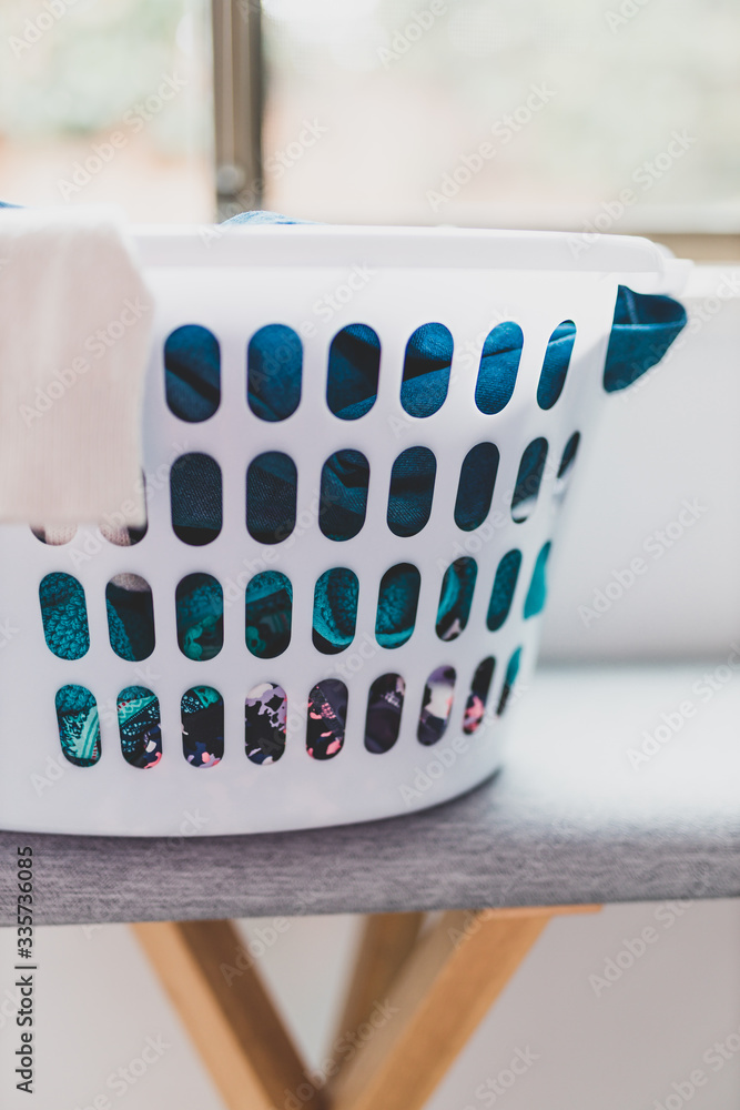 routines and life at home concept, laundry basket iwth mixed clothes on ...