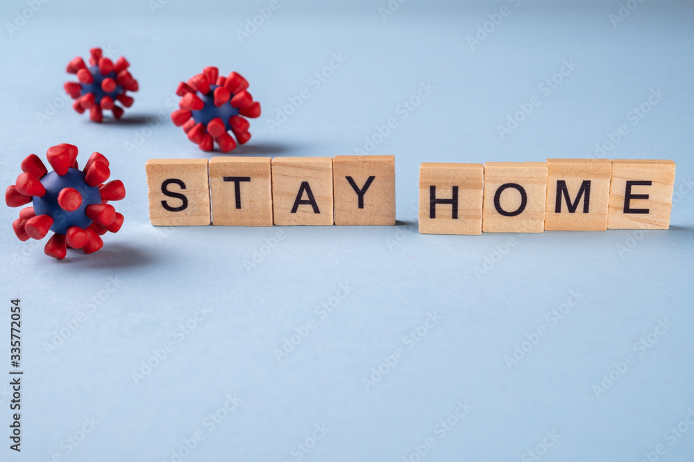Stay home stay safe concept made up of wooden letters and models of ...