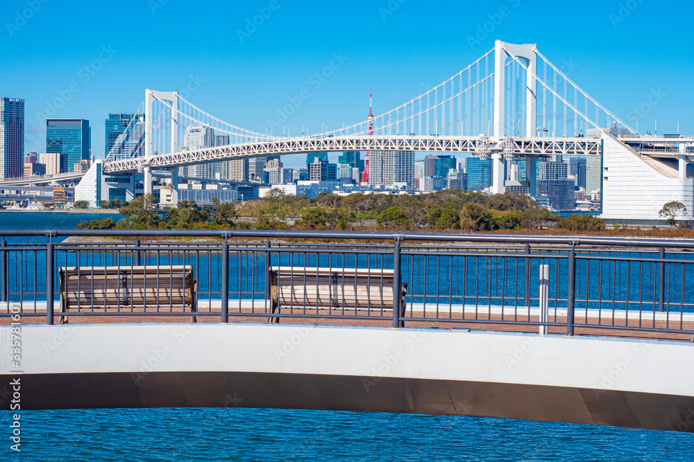 Japan. Tokyo Bridges. Benches overlooking the rainbow bridge. White ...