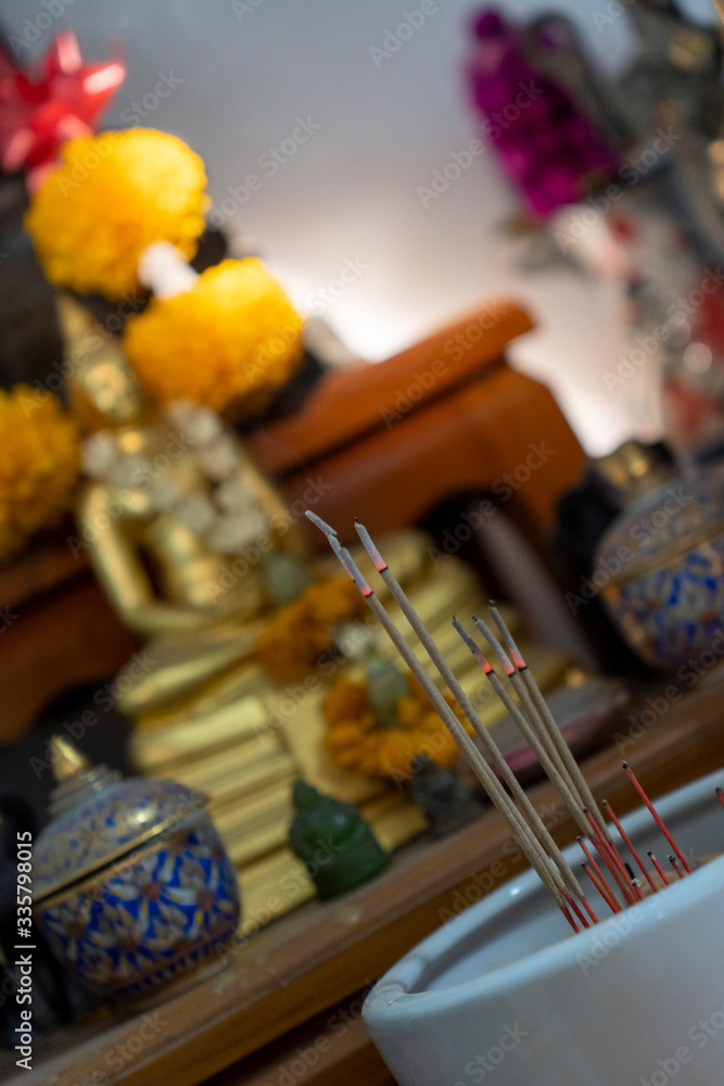 An incense burner with lit incense sticks used for worship is placed in ...
