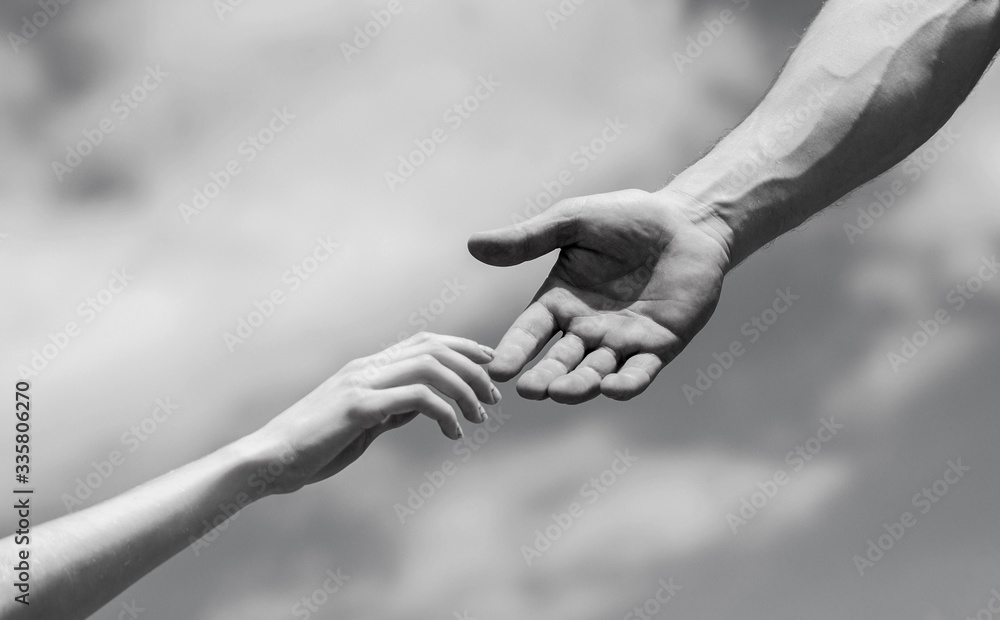 Giving a helping hand. Hands of man and woman on blue sky background ...