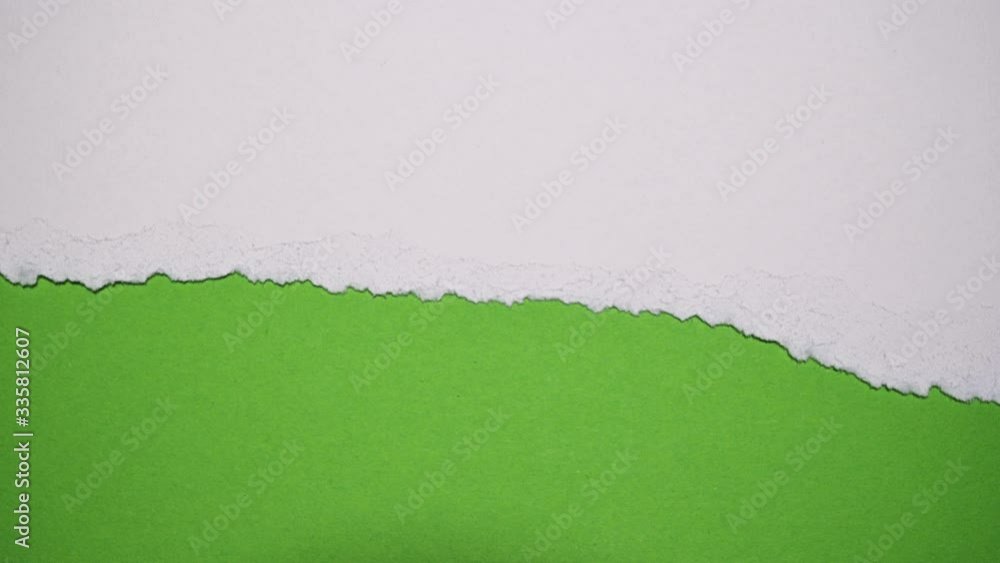 Tearing white paper horizontal revealing a green screen Stock Video ...