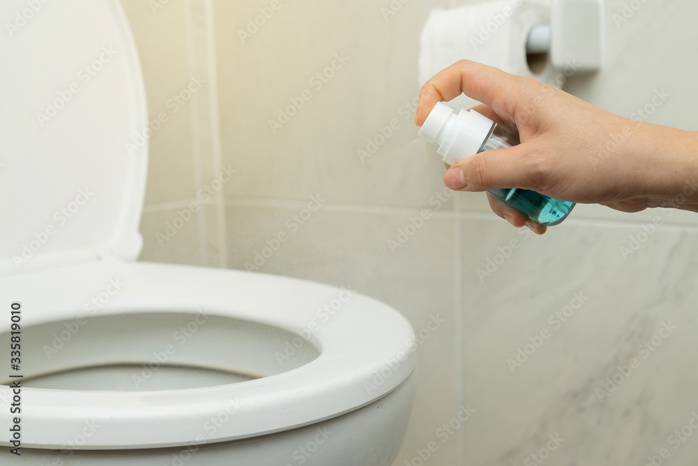 disinfect, sanitize, hygiene care. people using alcohol spray on toilet ...