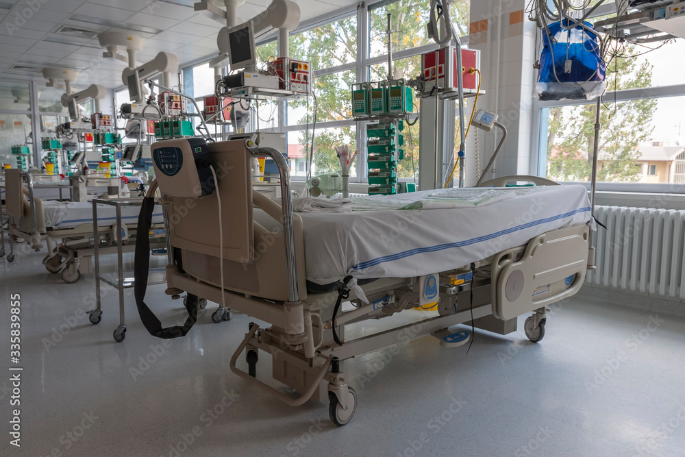 Intensive care unit in hospital, beds with monitors an ventilators, a ...