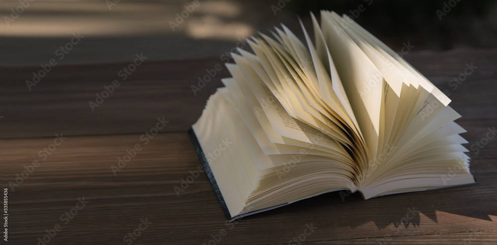open book on the table, with wind turning its pages Stock Photo | Adobe ...