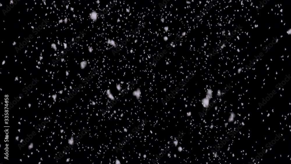 Snow flakes gently and slowly falling down from the sky. Black ...