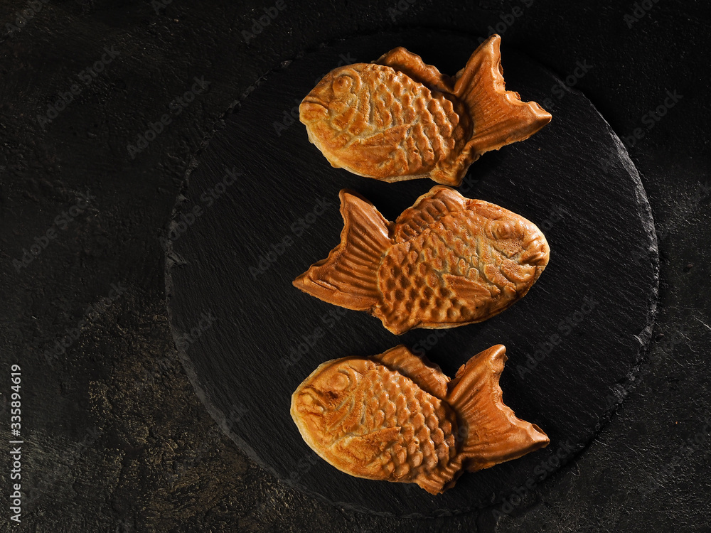 traditional japanese dessert tayaki. sweet waffles in the form of fish ...