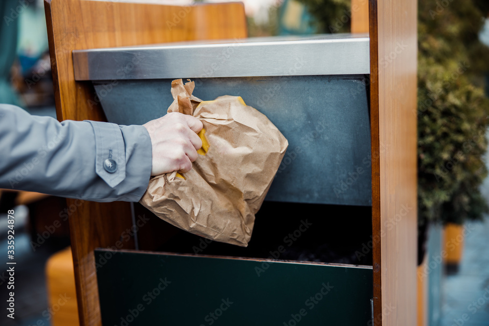 Caucasian man standing near an outdoor garbage can Stock Photo | Adobe ...
