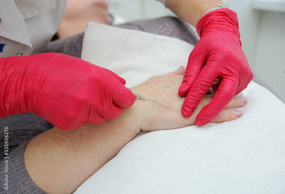 doctor cosmetologist dermatologist conducts a session of mesotherapy or ...