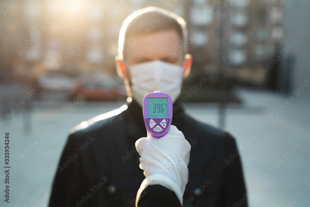 Operator check fever by digital thermometer visitor at information ...