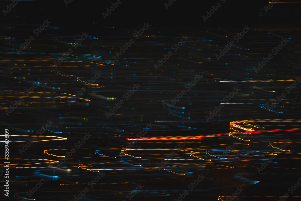 Lights trails in the black background. Color overlay light pattern ...