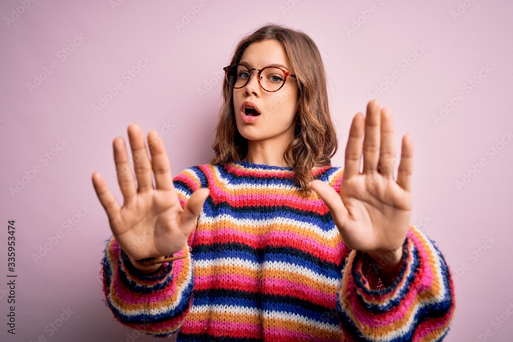 Young beautiful blonde girl wearing glasses and casual sweater over ...