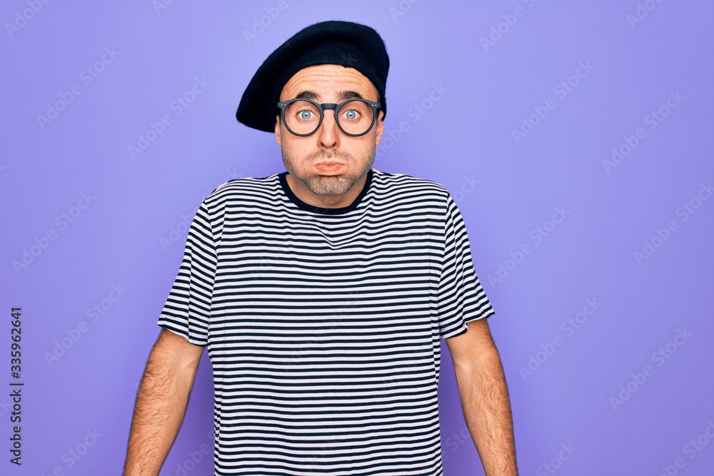 Handsome man with blue eyes wearing striped t-shirt and french beret ...