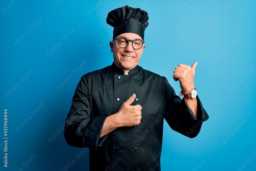 Middle age handsome grey-haired chef man wearing cooker uniform and hat ...