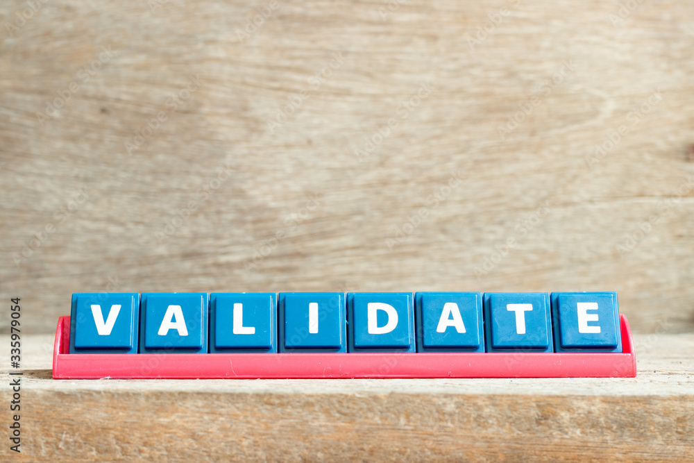 Tile letter on red rack in word validate on wood background Stock Photo ...