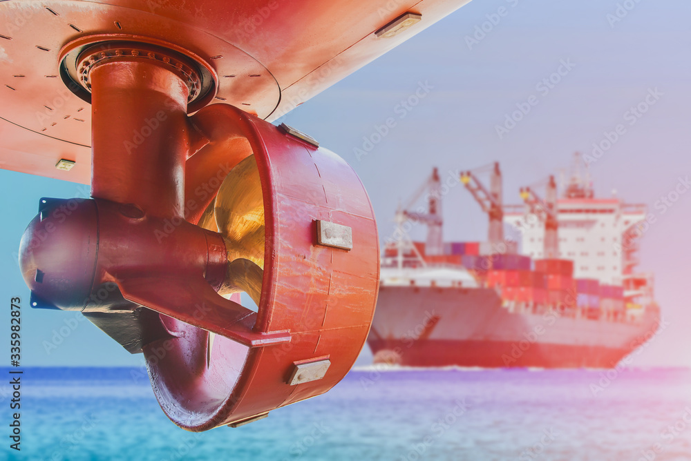 Low angle view propeller in rope guard with rudder at stern ship in ...