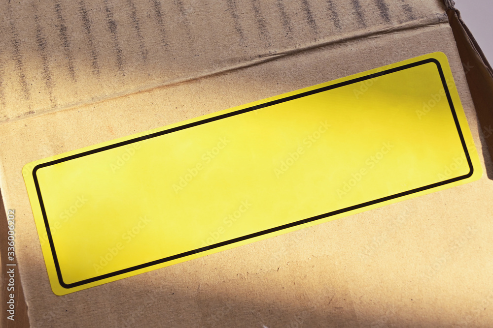 blank yellow label sticker tab of warning sign on carton paper box ...