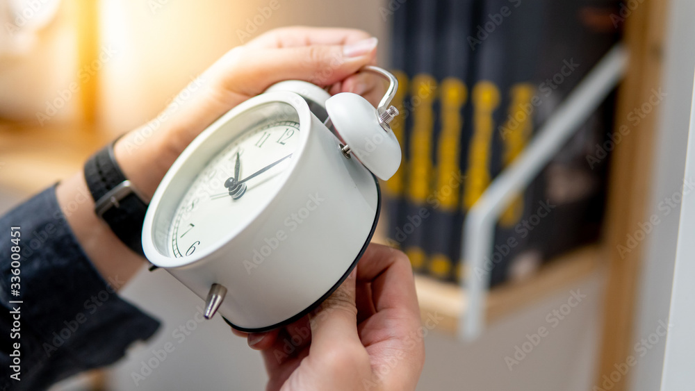 Male hand adjusting or changing the time on white clock. Time ...