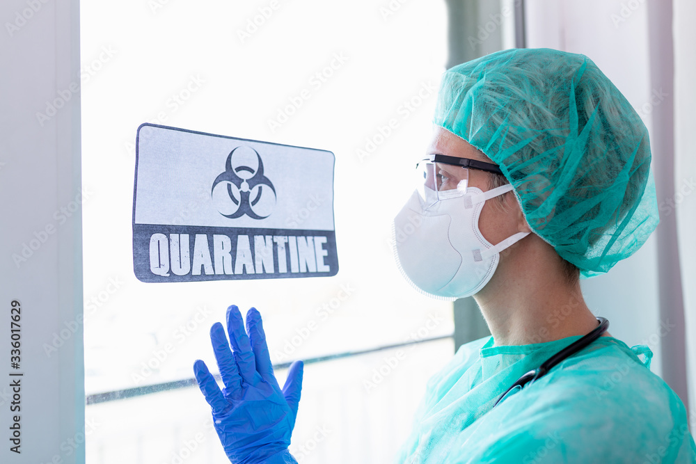 Worried female doctor looking through the hospital window, Quarantine ...