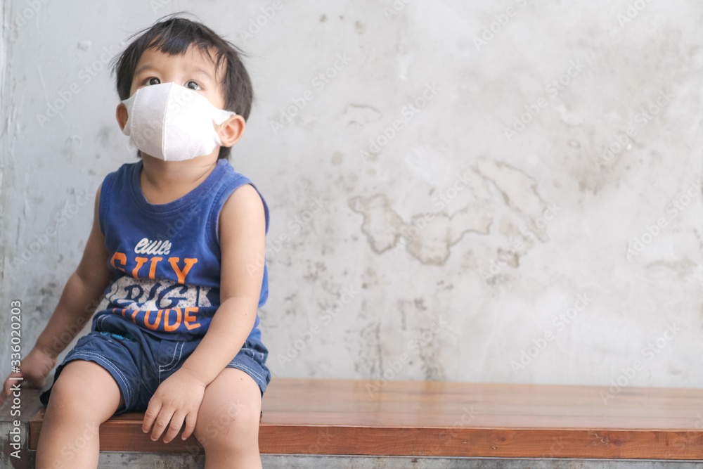 Little boy wear white mask protect Pm2.5 amd covid 19 sitting in cafe ...