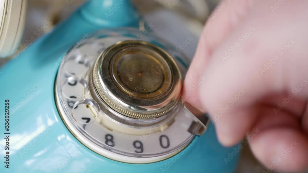 Close up view of old style telephone dialing. Antique blue telephone ...