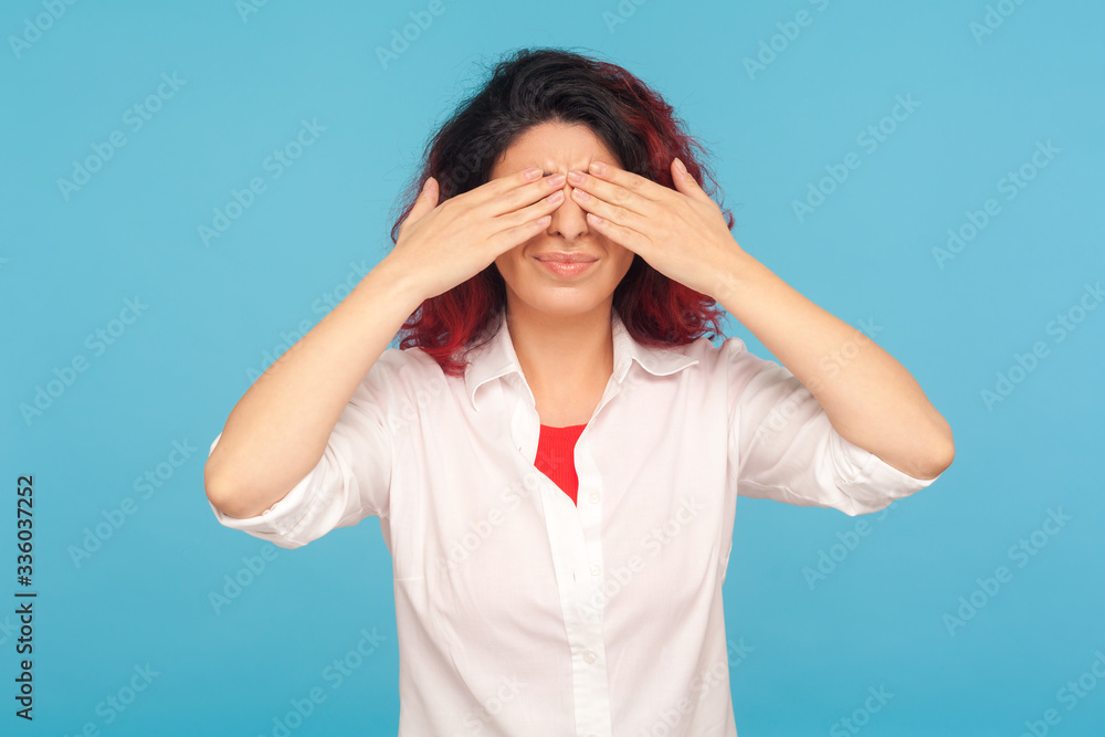 Portrait of embarrassed scared woman in white shirt covering eyes with ...
