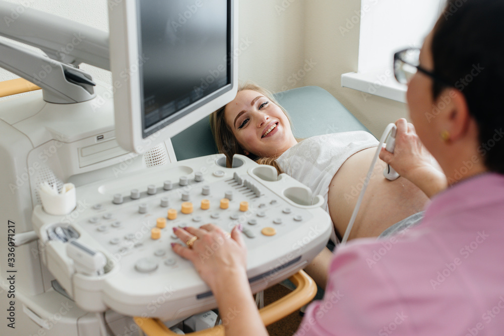 Close-up ultrasound device during a medical examination of a pregnant ...